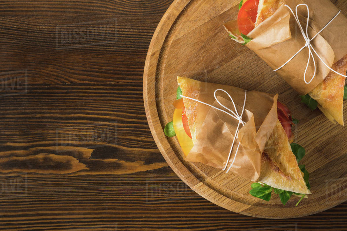 Top view of two delicious panini on cutting board - Stock Photo - Dissolve