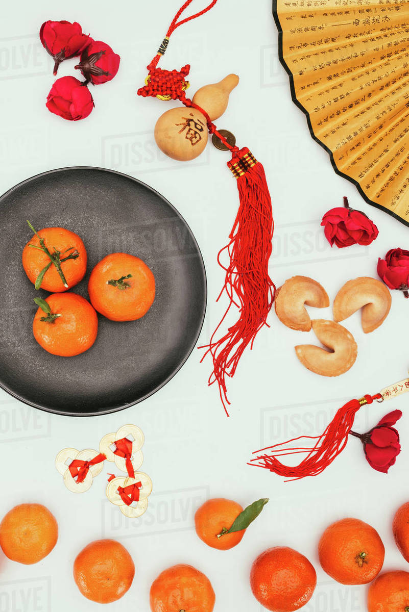 Top view of chinese fortune cookies with tangerines and traditional ...