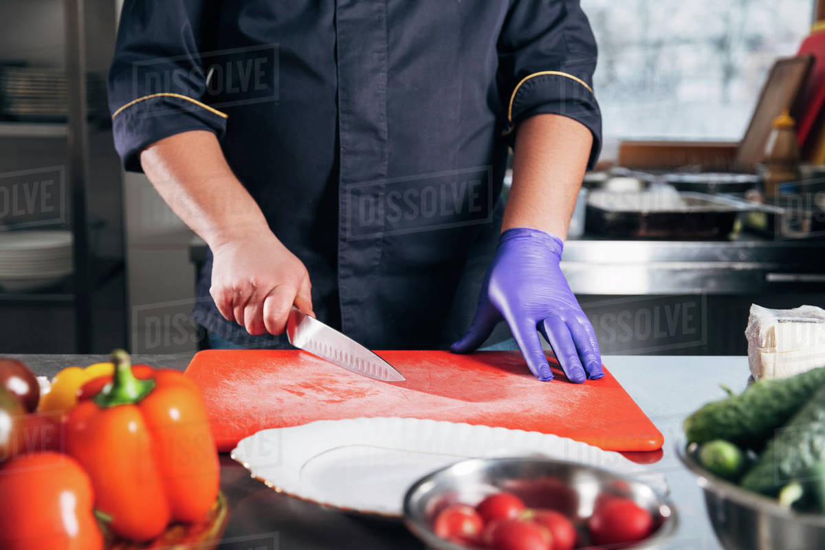 Cropped shot of chef with knife at workplace in restaurant - Royalty ...