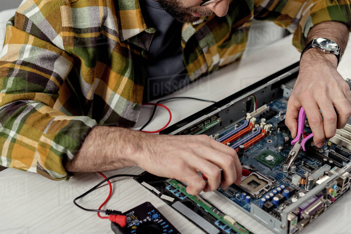 man using multimeter and tongs while fixing pc - Royalty-free Stock ...