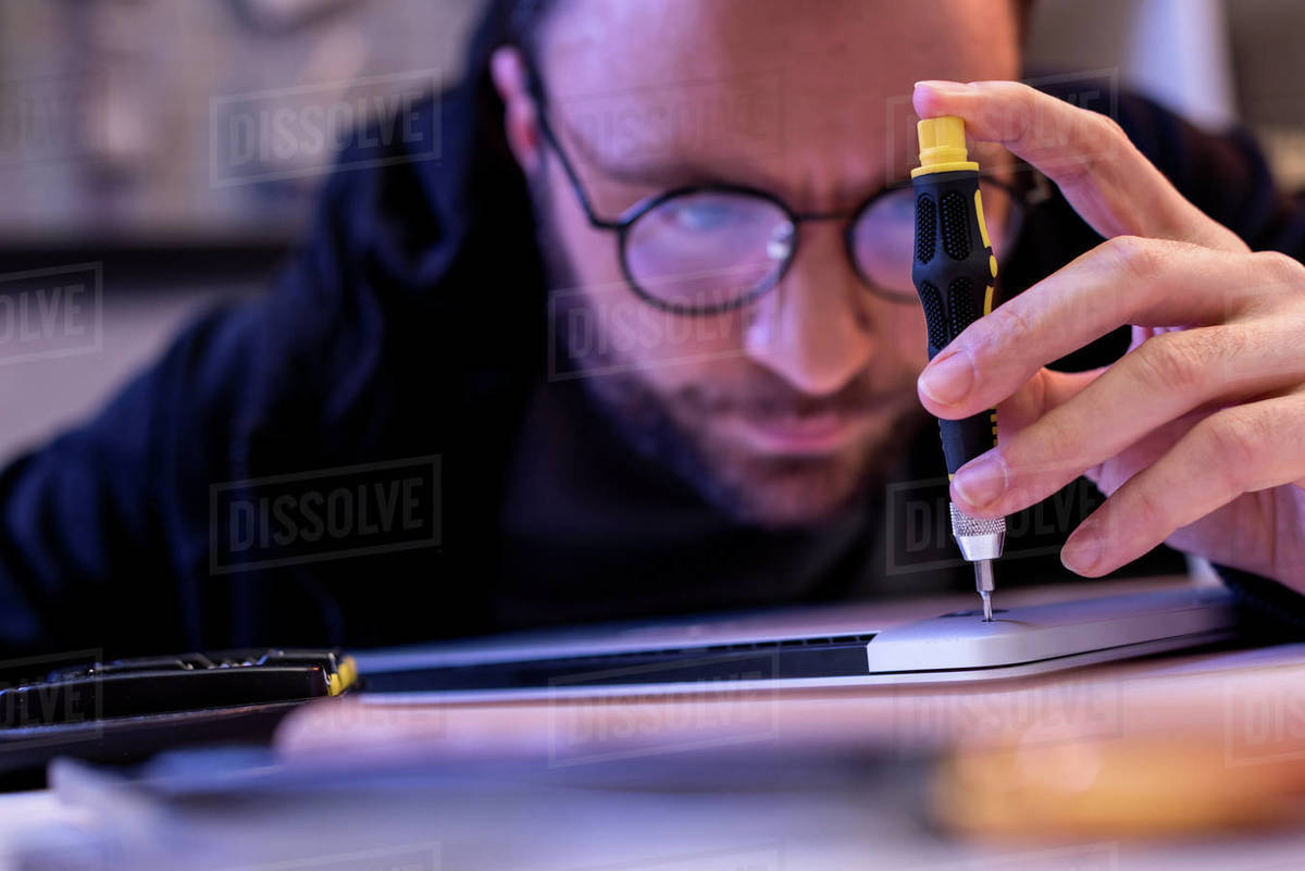 Man using screwdriver while fixing digital tablet - Royalty-free Stock ...