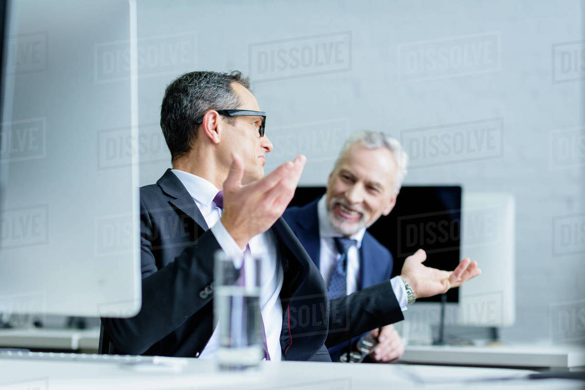 Business colleagues having conversation during work in office - Stock ...