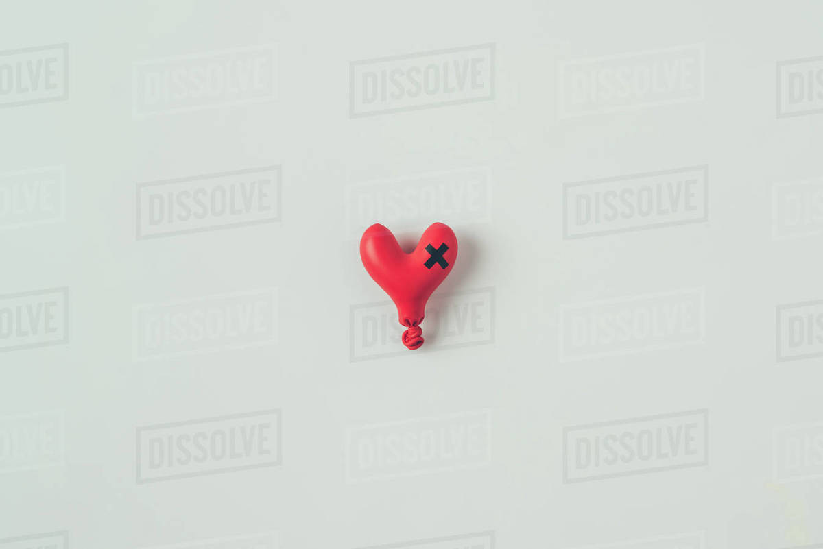 Top view of deflated heart shaped balloon with insulating tape cross ...