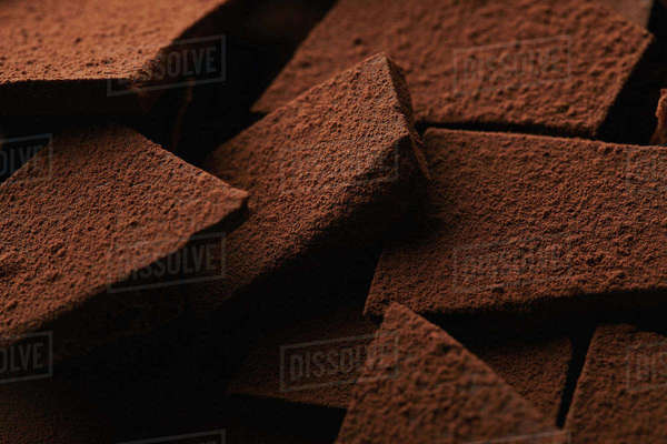 Close up view of heap of chocolate bars in cocoa powder - Royalty-free ...