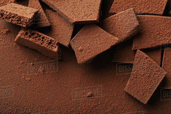 Close up view of heap of chocolate bars in cocoa powder - Royalty-free ...