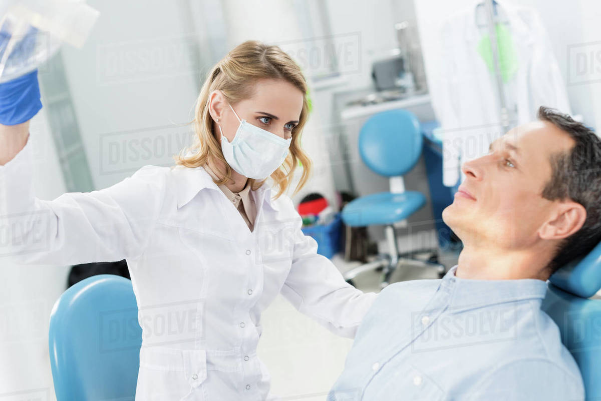 Doctor checking patient teeth in modern dental clinic - Stock Photo ...