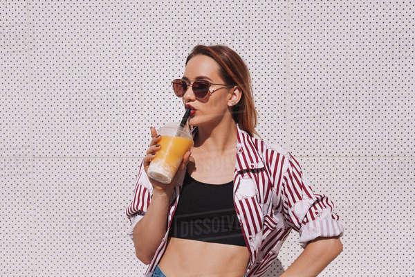 Beautiful young woman with mango shake in plastic cup - Royalty-free ...