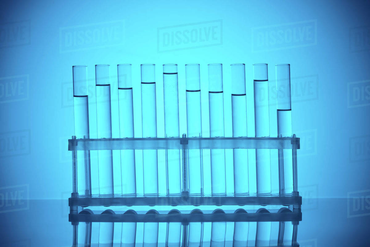 Row of glass tubes with liquid on stand on blue - Royalty-free Stock ...