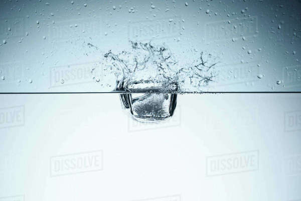 Ice cube in water with splash, isolated on white - Royalty-free Stock ...