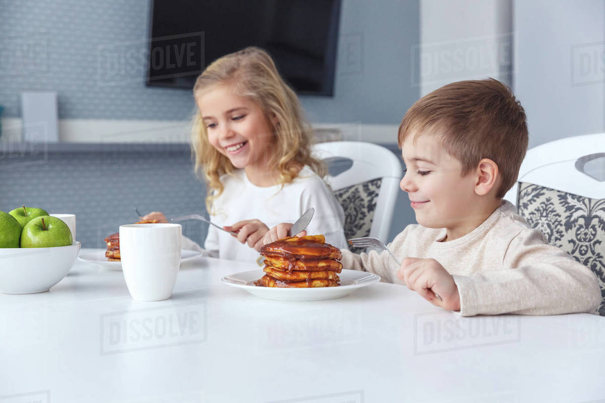 Adorable little kids having breakfast together - Royalty-free Stock ...