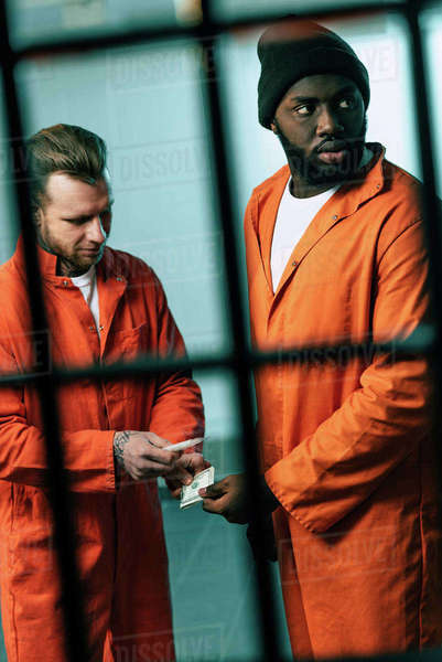 criminal buying drugs at african american prisoner in prison cell ...