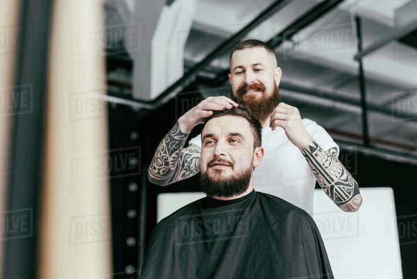 barber styling customer hair at barbershop - Royalty-free Stock Photo ...