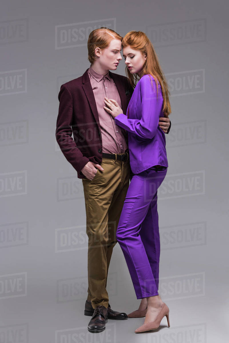 Side view of young stylish models isolated on grey - Royalty-free Stock ...