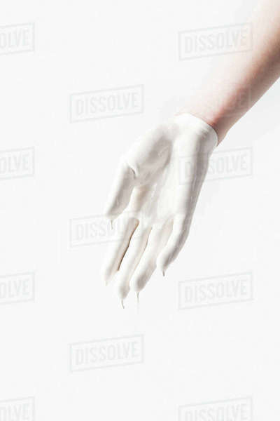 Cropped image of woman in white paint in shape of glove isolated on ...