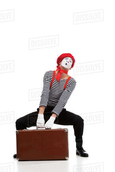Mime lifting up heavy brown suitcase isolated on white - Royalty-free ...