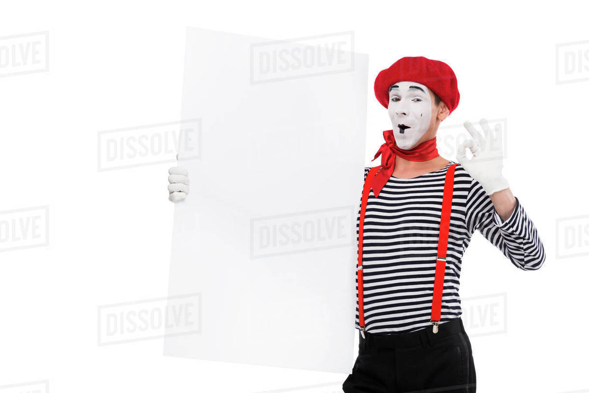 Happy mime holding empty board and showing ok sign isolated on white ...