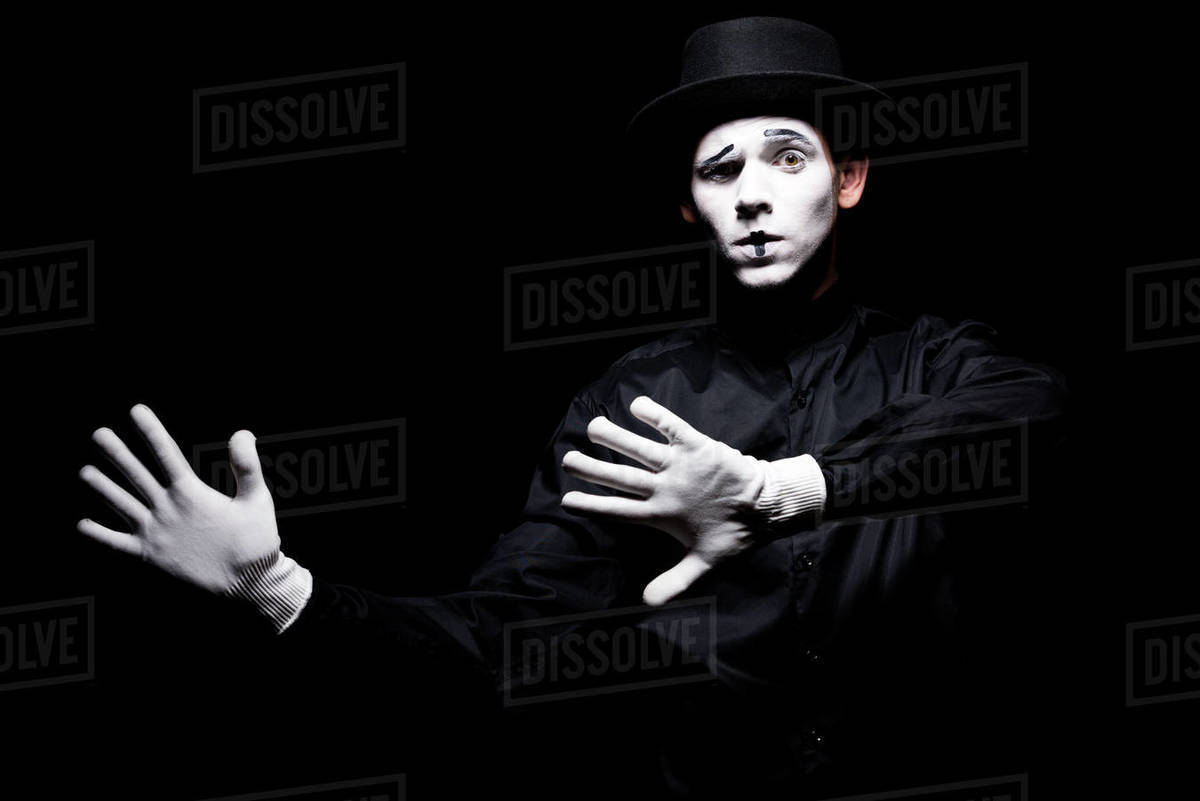 Mime pretending touching something isolated on black - Royalty-free ...