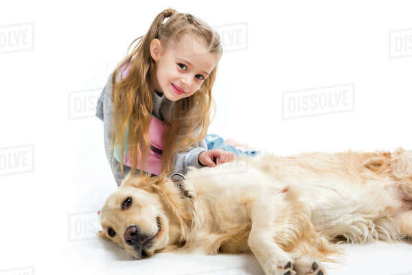 Child and lying dog looking at camera isolated on white - Royalty-free ...
