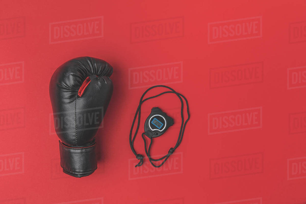 top view of boxing glove with stopwatch on red tabletop - Stock Photo ...