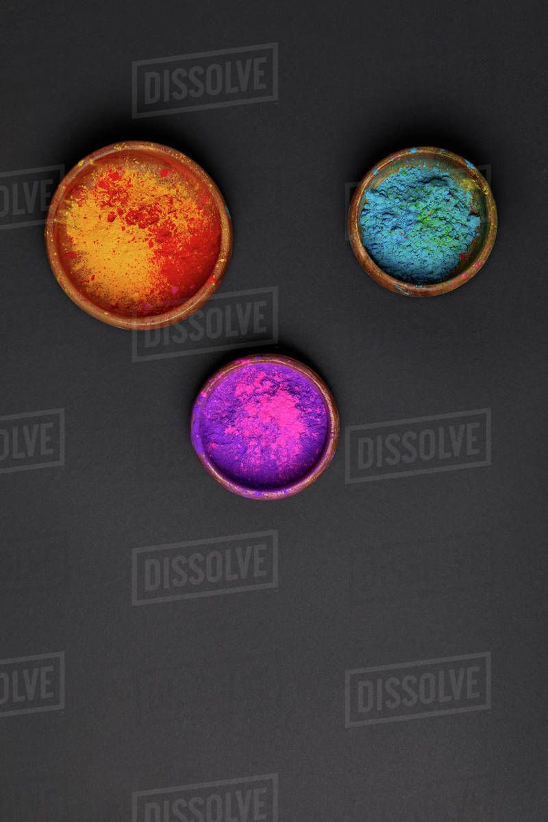 Top view of traditional holi powder in bowls on grey surface, Hindu ...
