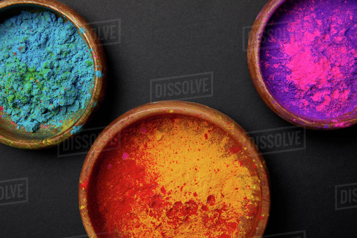 Top view of colorful holi powder in paint on grey surface, Hindu spring ...