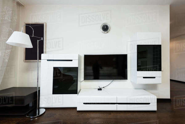 Close up view of tv on wall in living room - Stock Photo - Dissolve