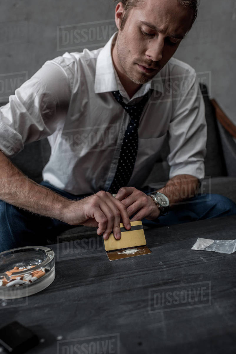 Businessman with drug addiction preparing to take cocaine - Stock Photo ...