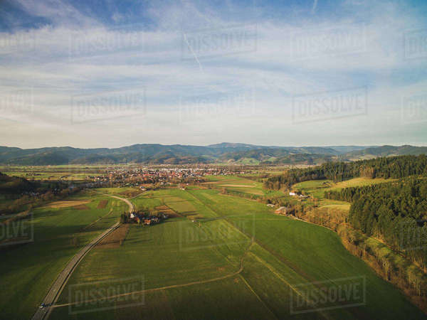 Aerial view of majestic landscape with green field and town in Germany ...