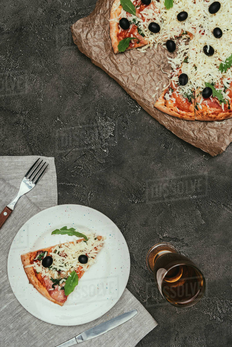 Pizza slice served on white plate on dark background - Royalty-free ...