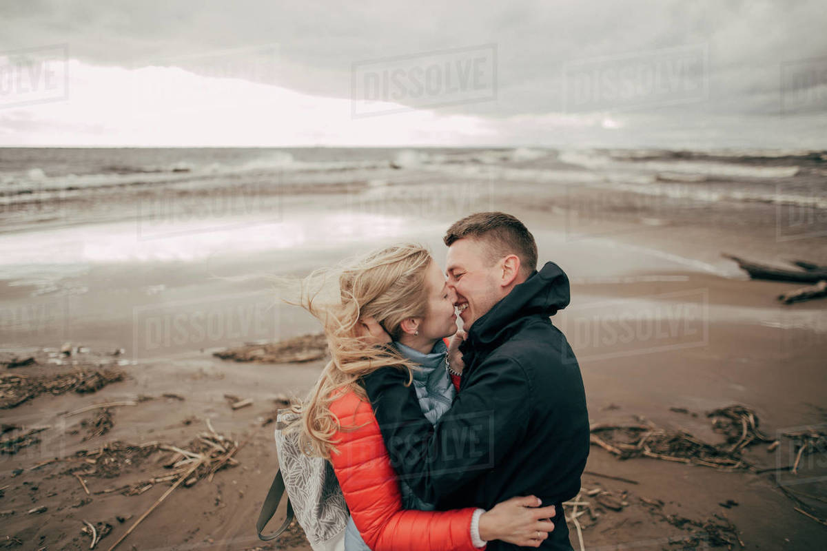 beautiful young couple kissing on sandy beach of Baltic sea - Stock ...