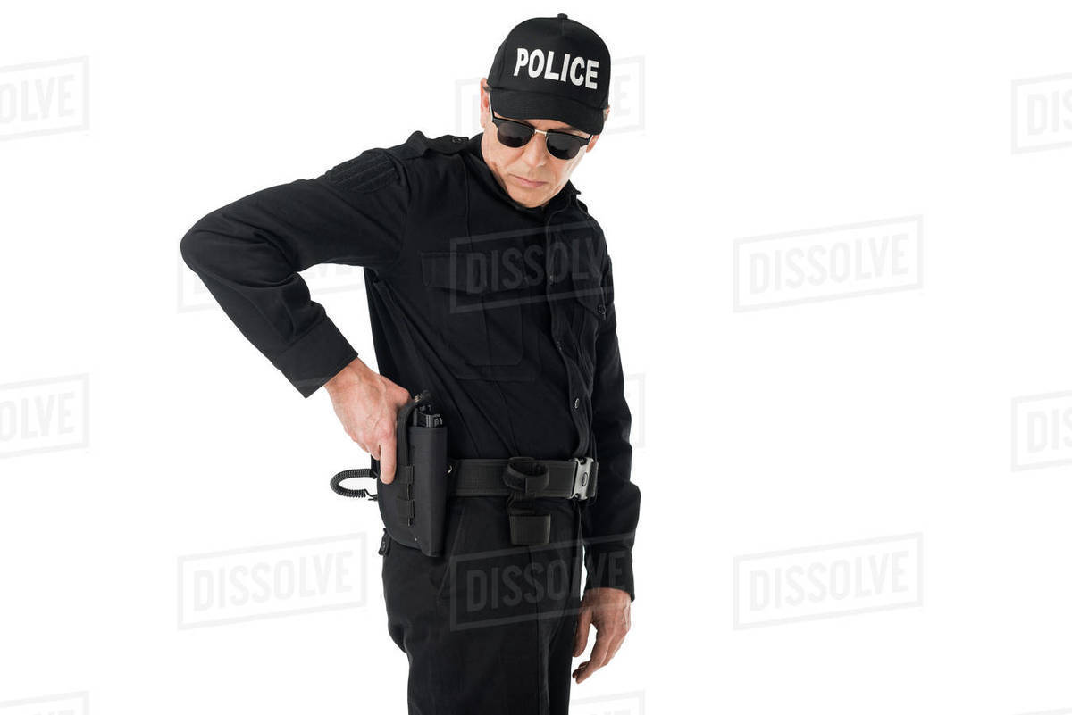 Policeman in uniform pulling out gun isolated on white - Royalty-free ...