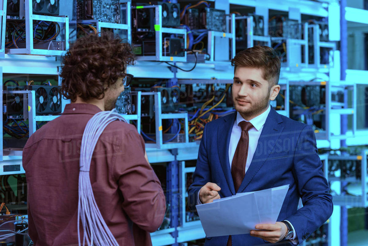 Handsome businessman and computer engineer working together at ...