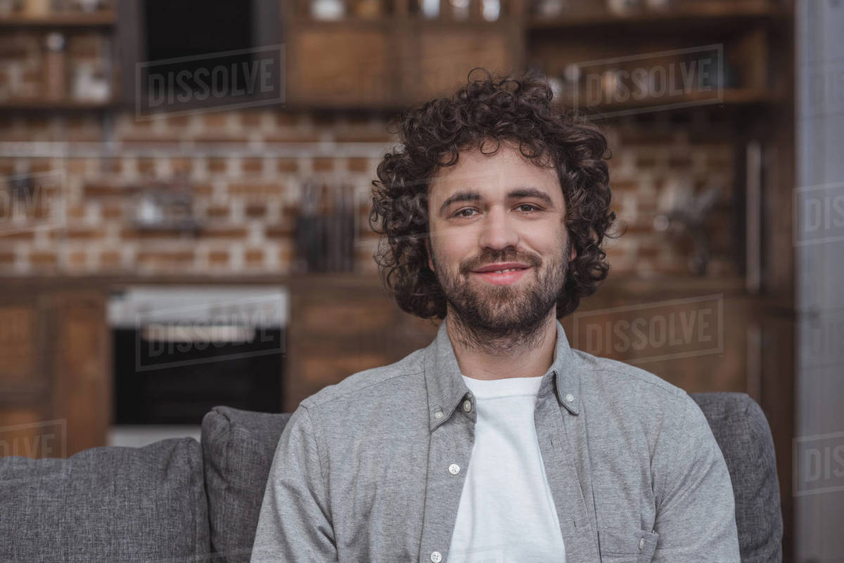 Portrait of handsome smiling man looking at camera at home - Royalty ...