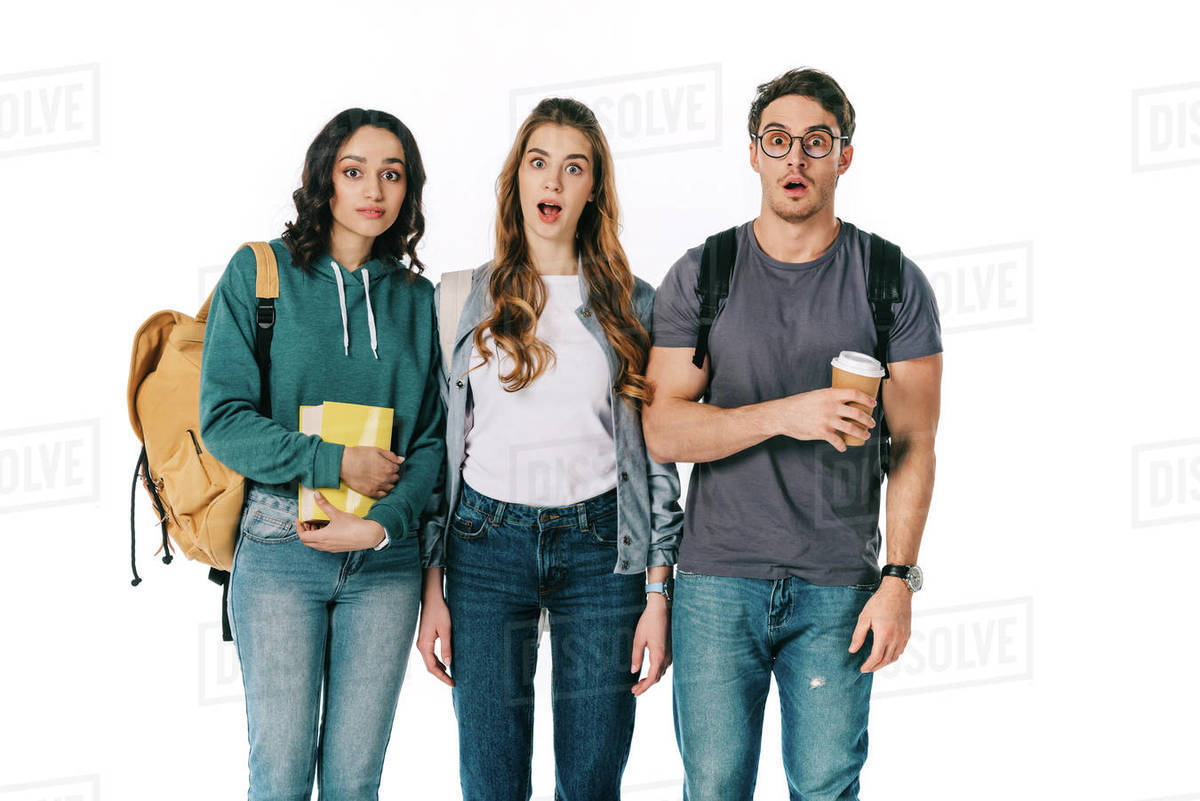 Shocked multicultural students looking at camera isolated on white ...