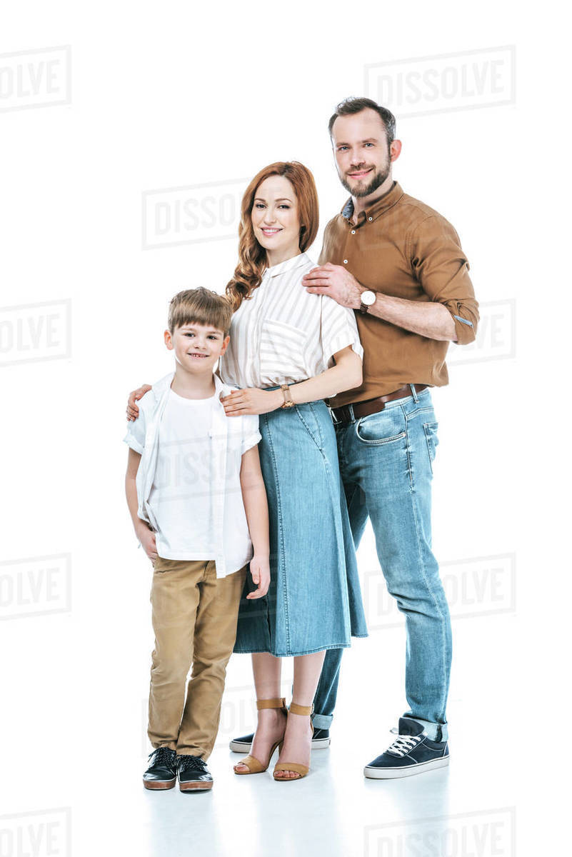 Happy parents with cute little son standing together and smiling at ...