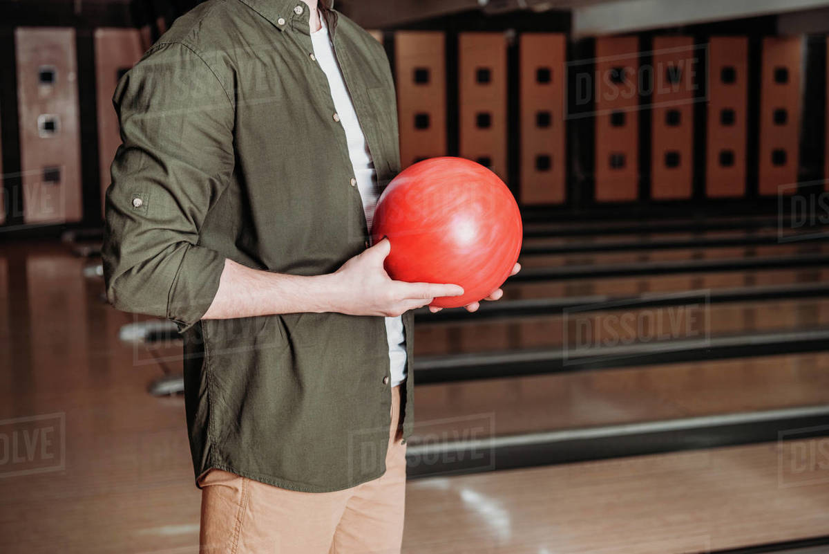 Cropped shot of man holding bowling ball at club - Royalty-free Stock ...