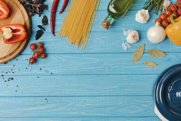 Top view of ingredients for cooking pasta on blue table - Royalty-free ...