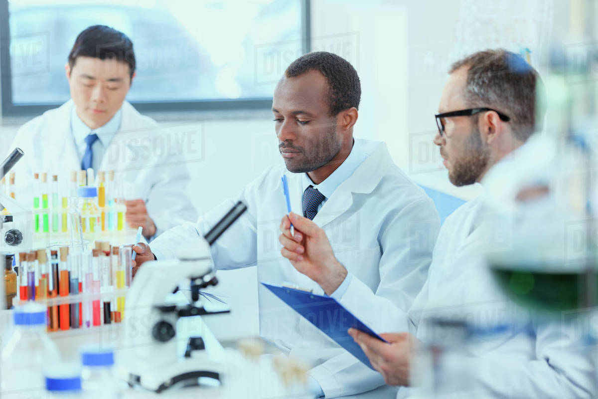 Young doctors in uniform working at testing laboratory, laboratory ...