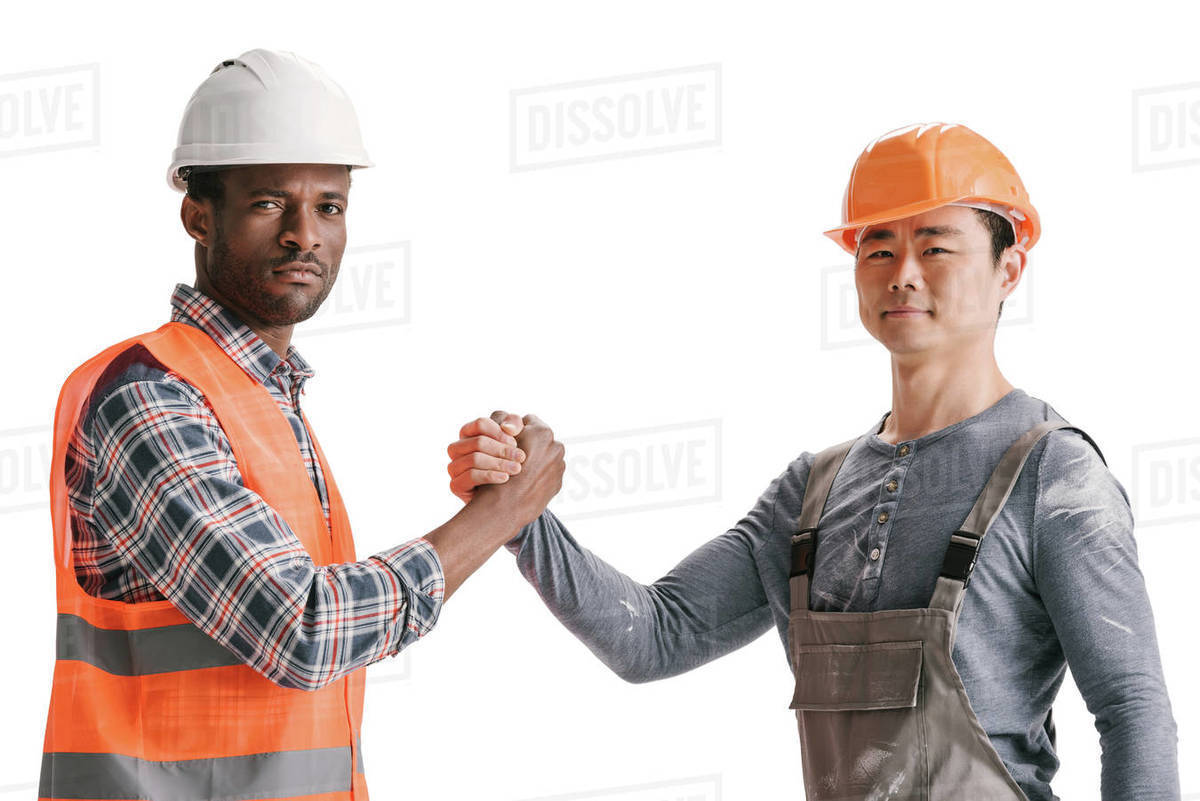 Team of african-american and asian construction workers isolated on ...