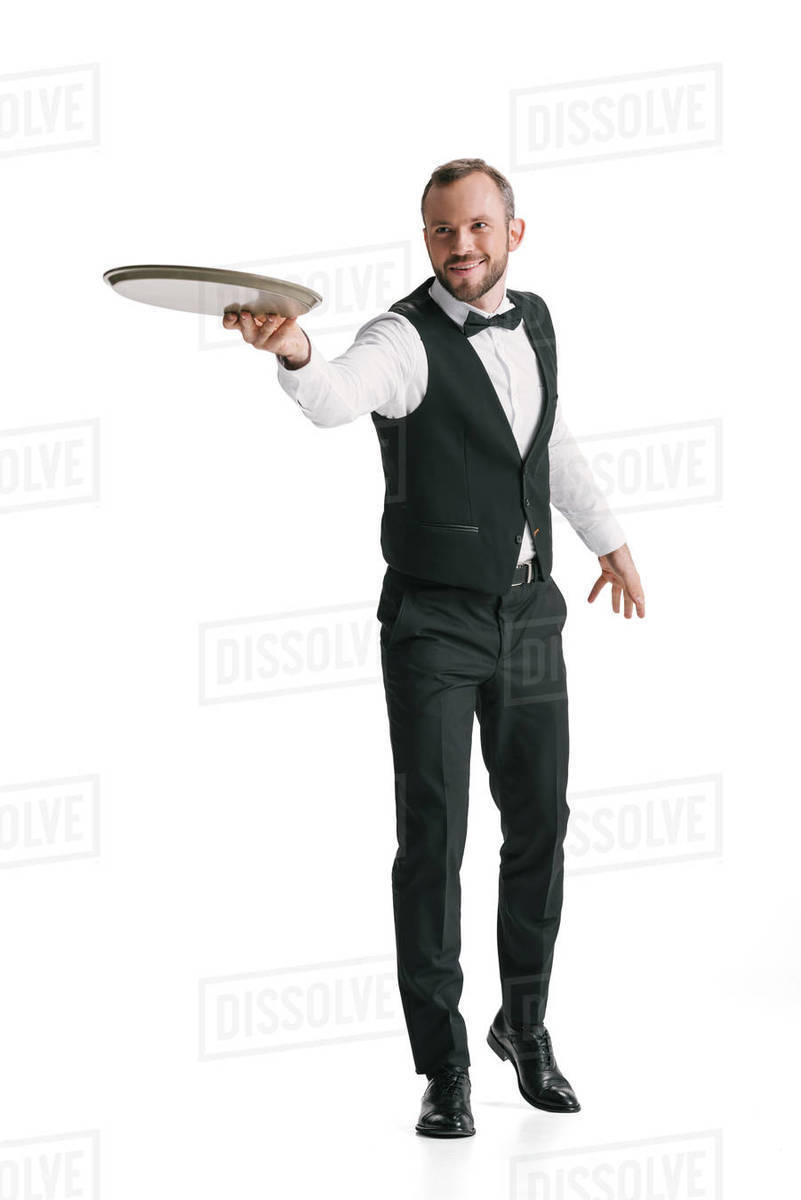 Smiling handsome waiter in suit with tray isolated on white - Royalty ...