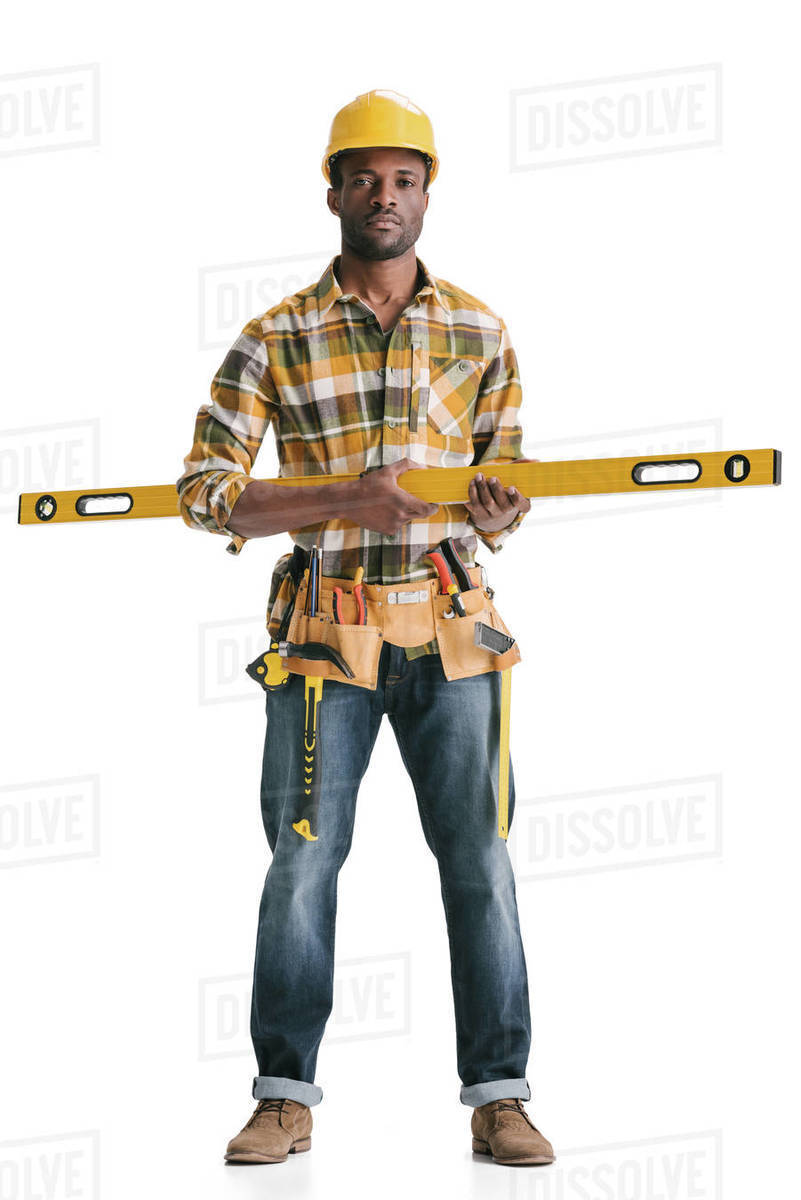 Serious african-american construction worker with leveling tool ...