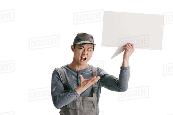 Mad builder holding blank speech bubble and screaming isolated on white ...