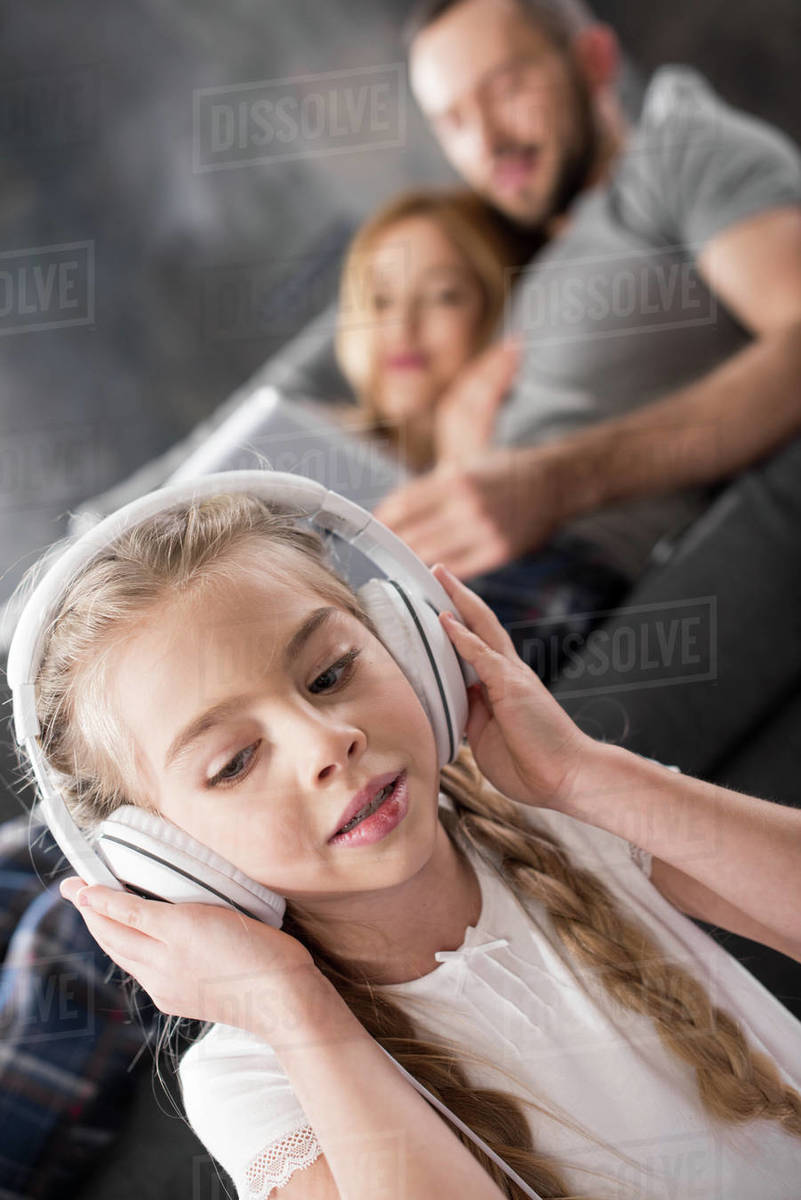 Portrait of cute little girl wearing white headphones - Royalty-free ...