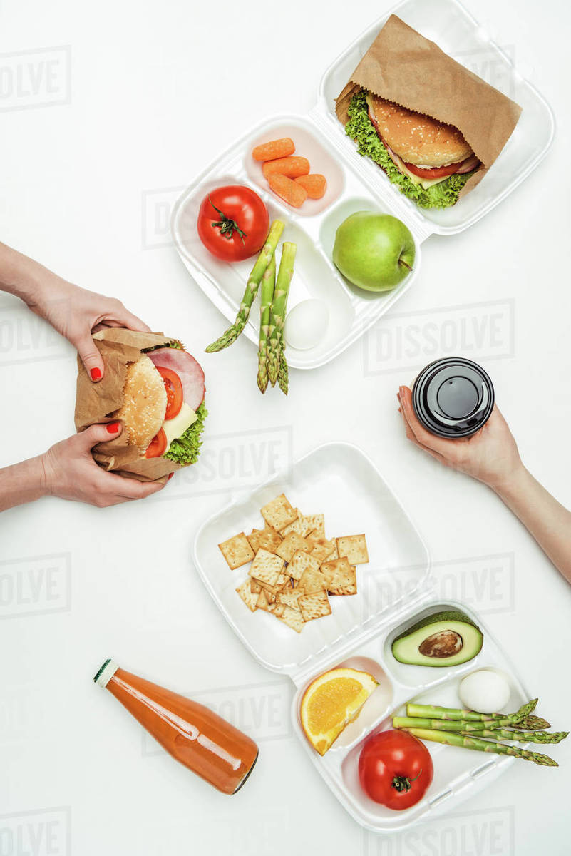 Cropped image of women having lunch isolated on white - Stock Photo ...