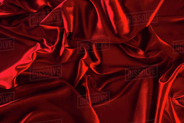 Red shiny silk fabric background - Stock Photo - Dissolve