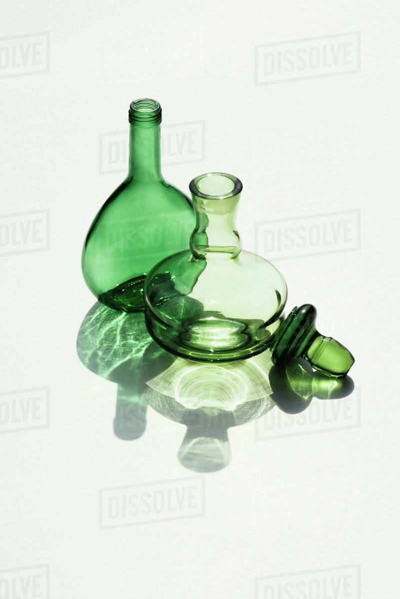 Close up view of empty glass bottles and cork on white backdrop - Stock ...