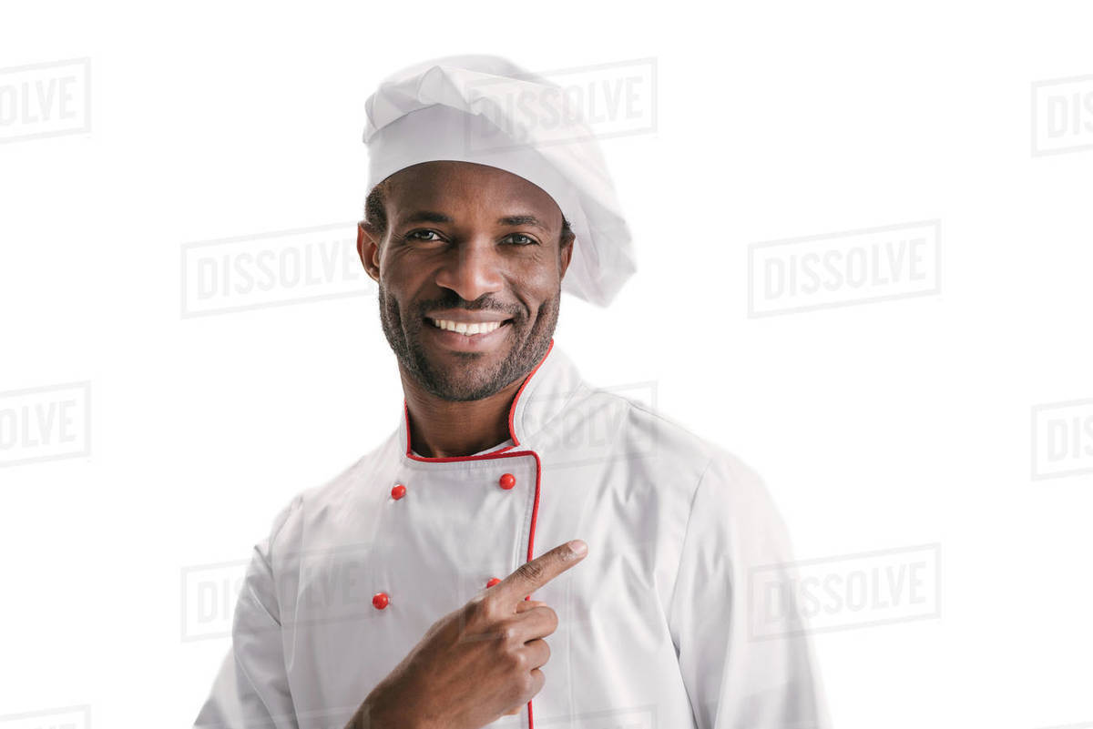 handsome african american chef pointing away isolated on white ...