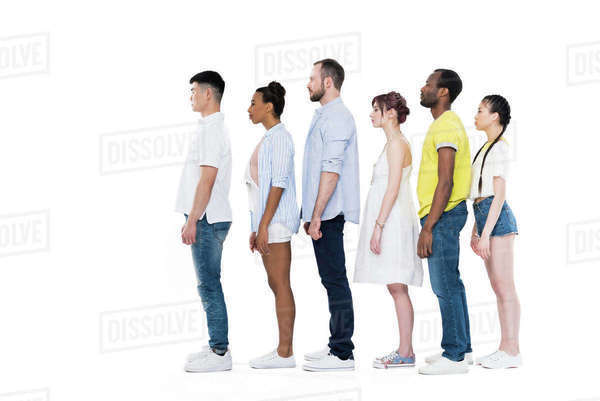 side view of young multiethnic people standing in row and smiling at ...