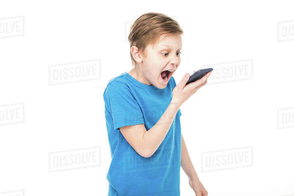 Emotional little boy screaming at smartphone isolated on white ...