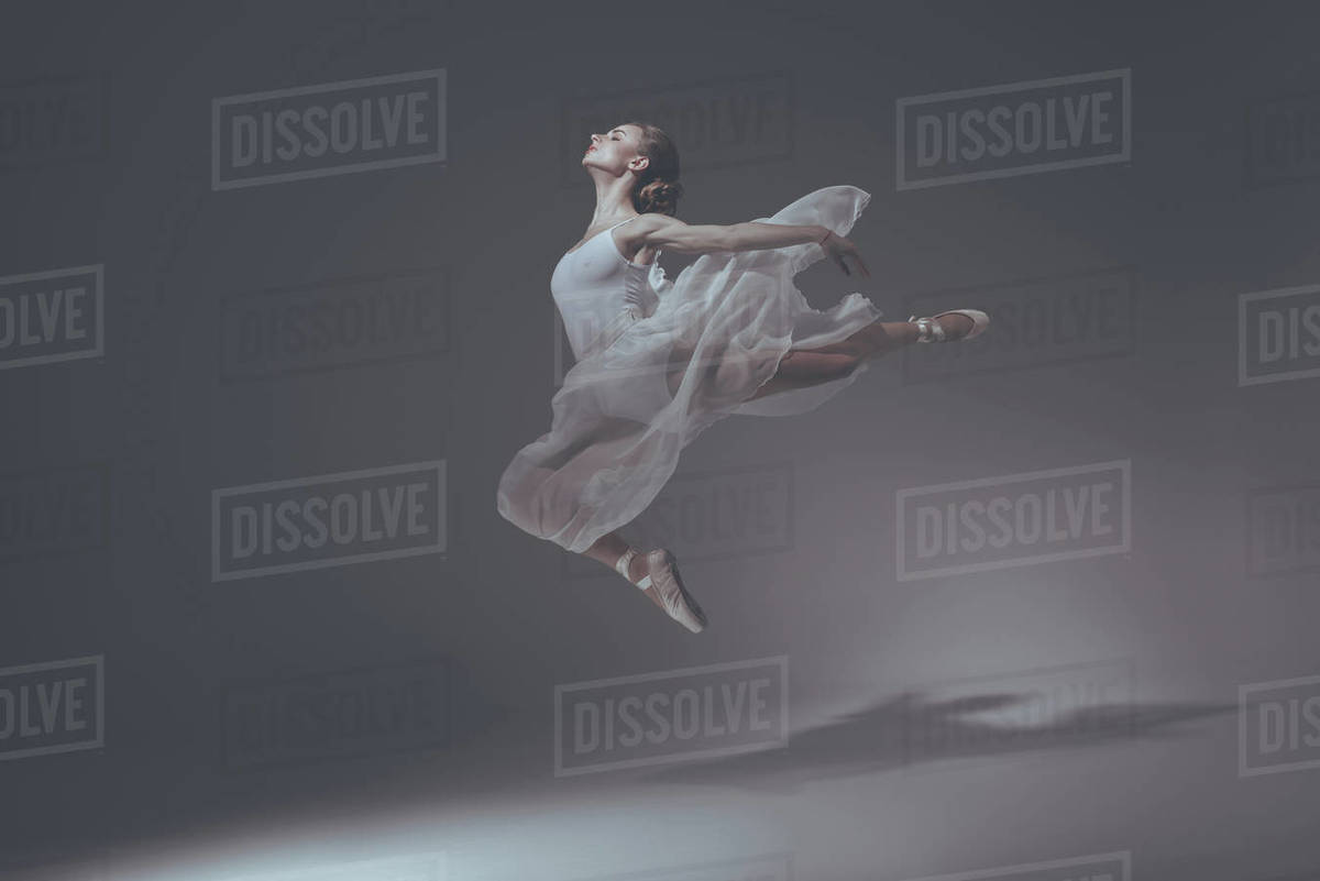 Beautiful elegant ballet dancer jumping in white dress - Stock Photo ...